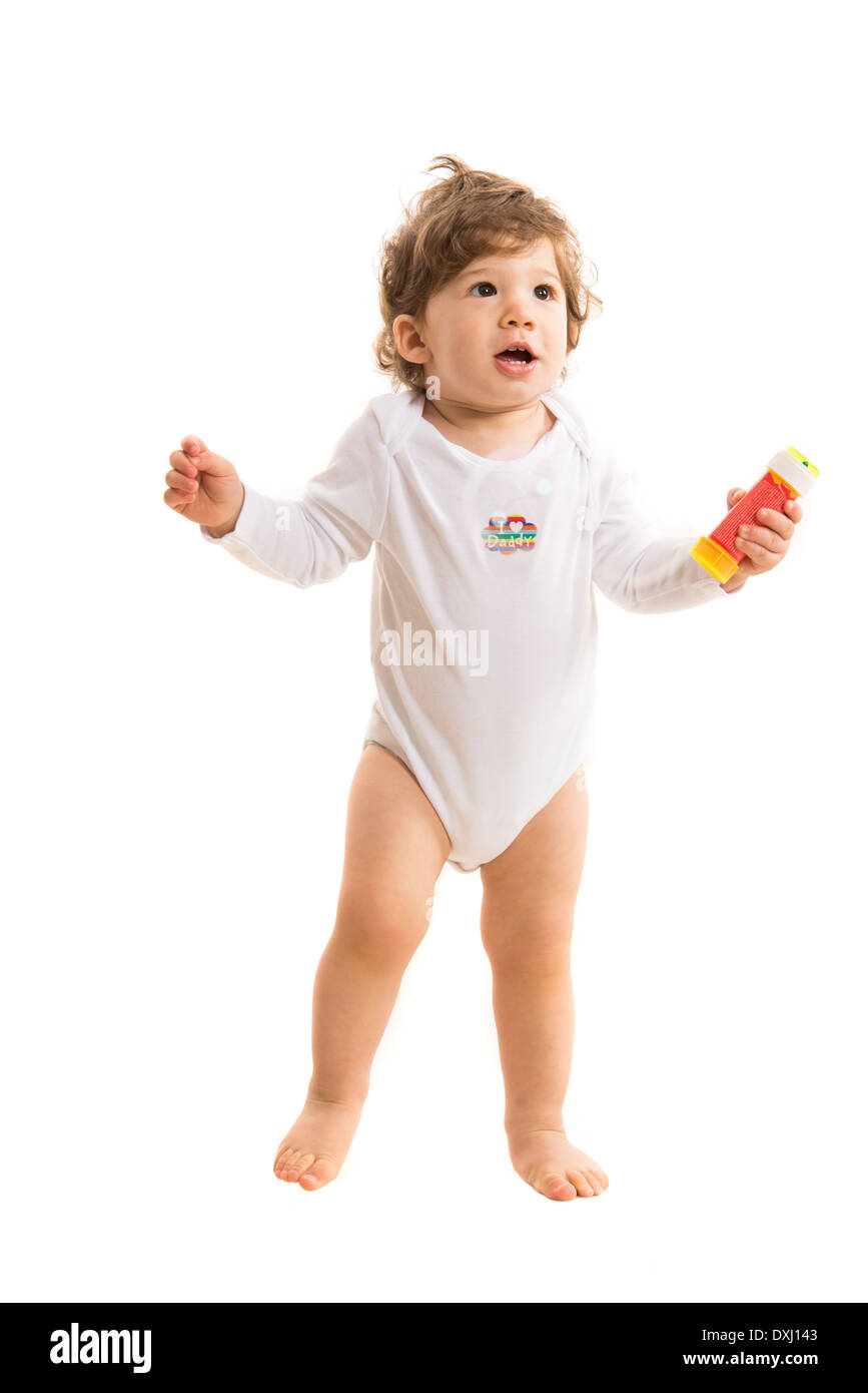 Full length of amazed toddler boy walking barefoot and looking to soap ...