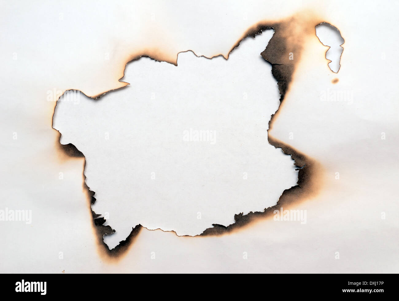 burnt hole in a paper Stock Photo - Alamy
