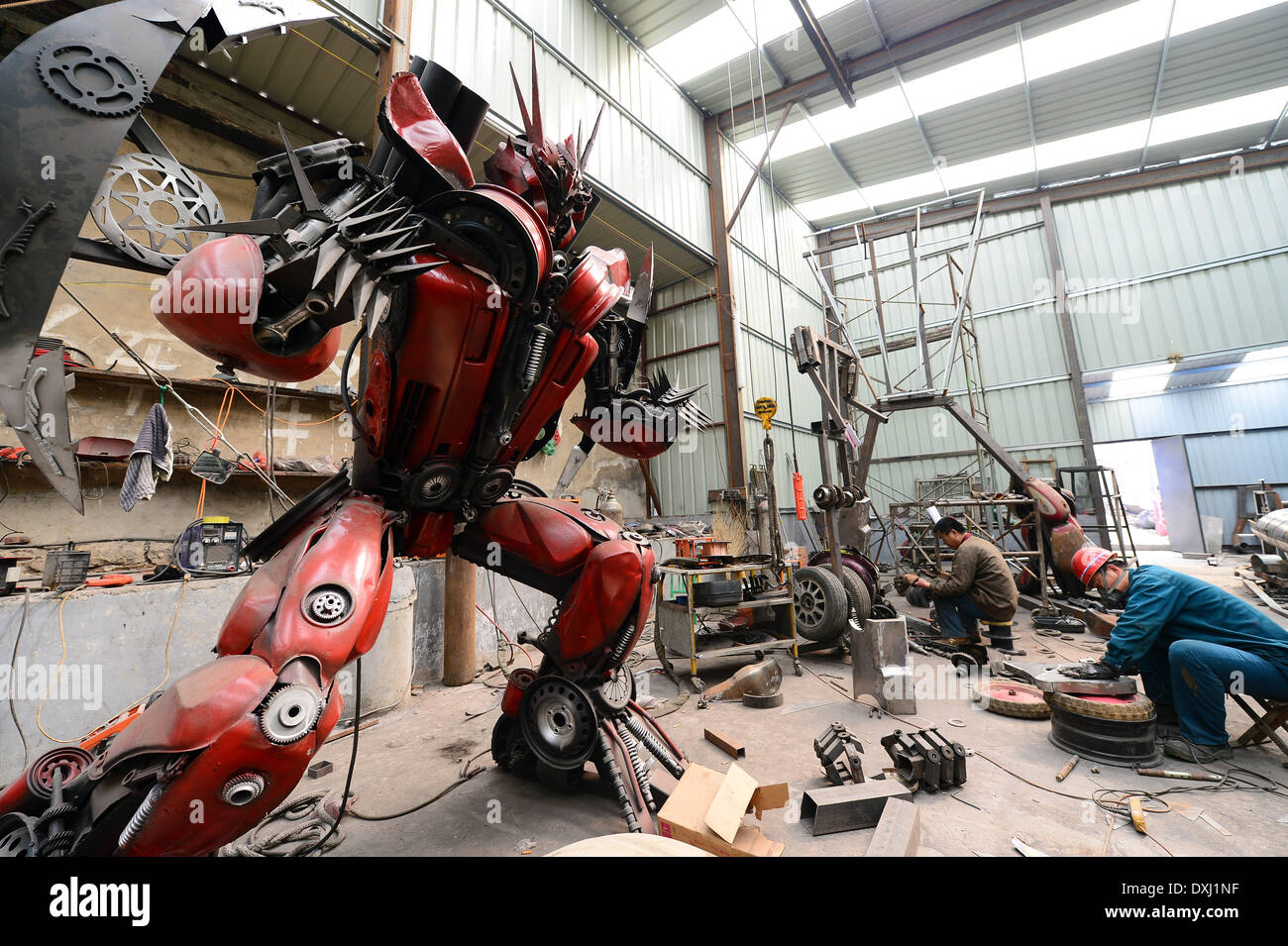Jinan, China's Shandong Province. 27th Mar, 2014. Workers prepare parts ...