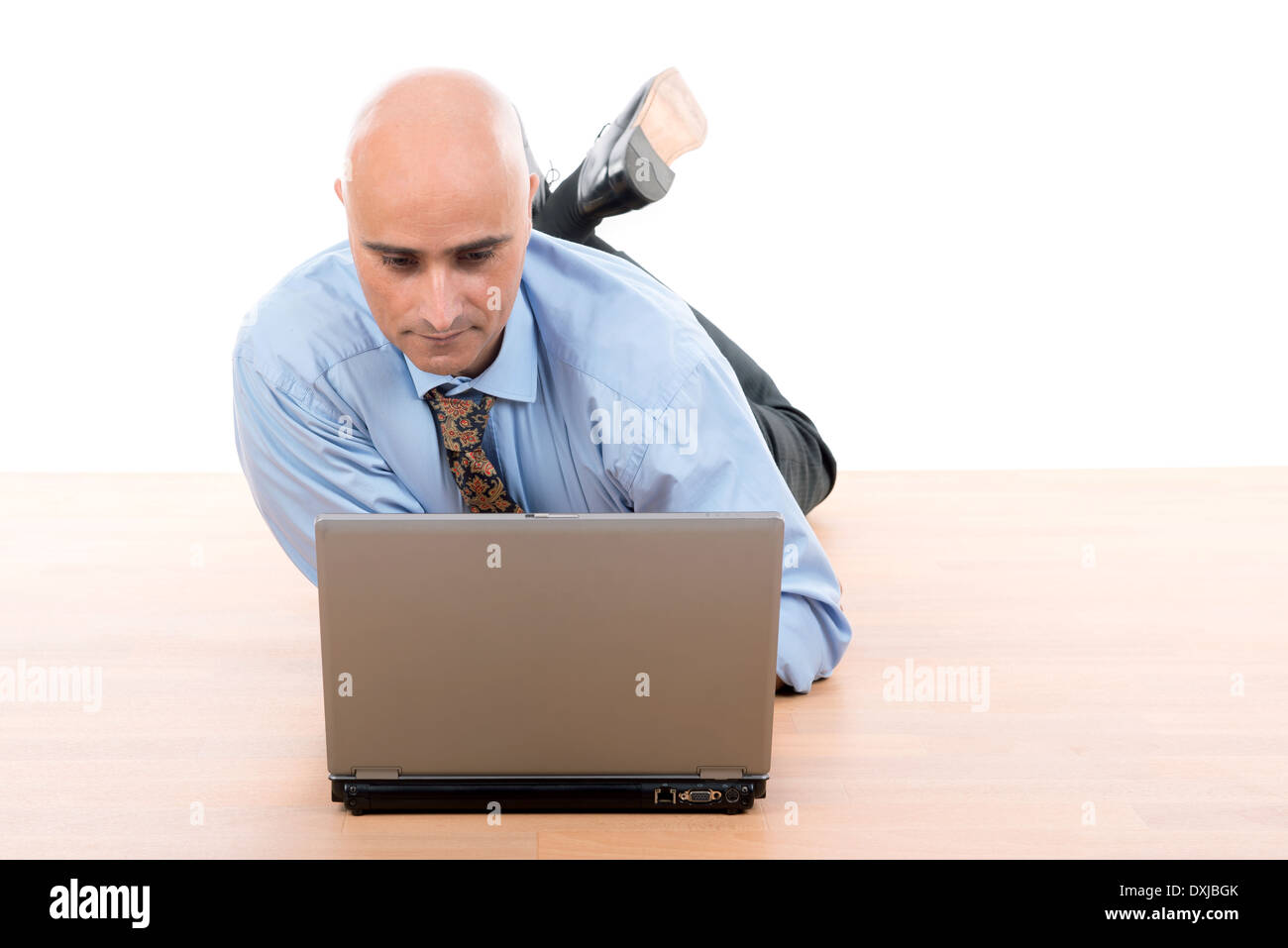 Businessman with laptop computer on the floor Stock Photo - Alamy