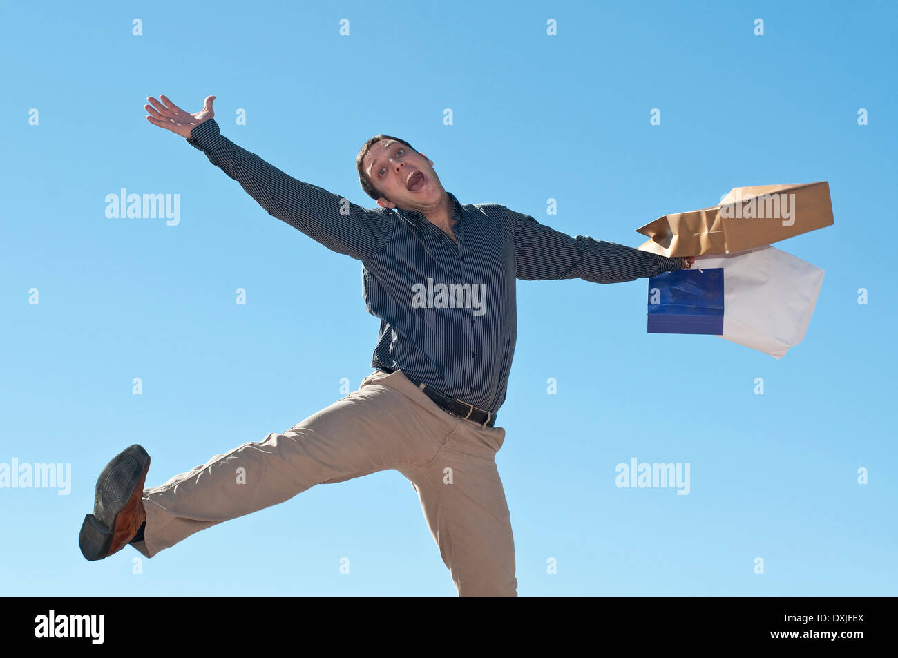 jumping man with shopping bags Stock Photo - Alamy