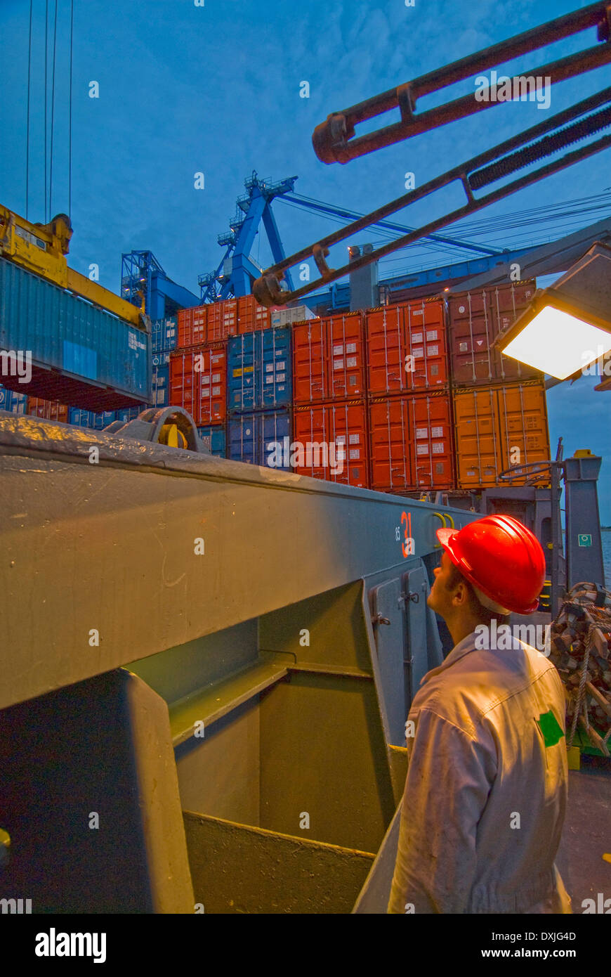 seaman watching container being loaded Stock Photo - Alamy