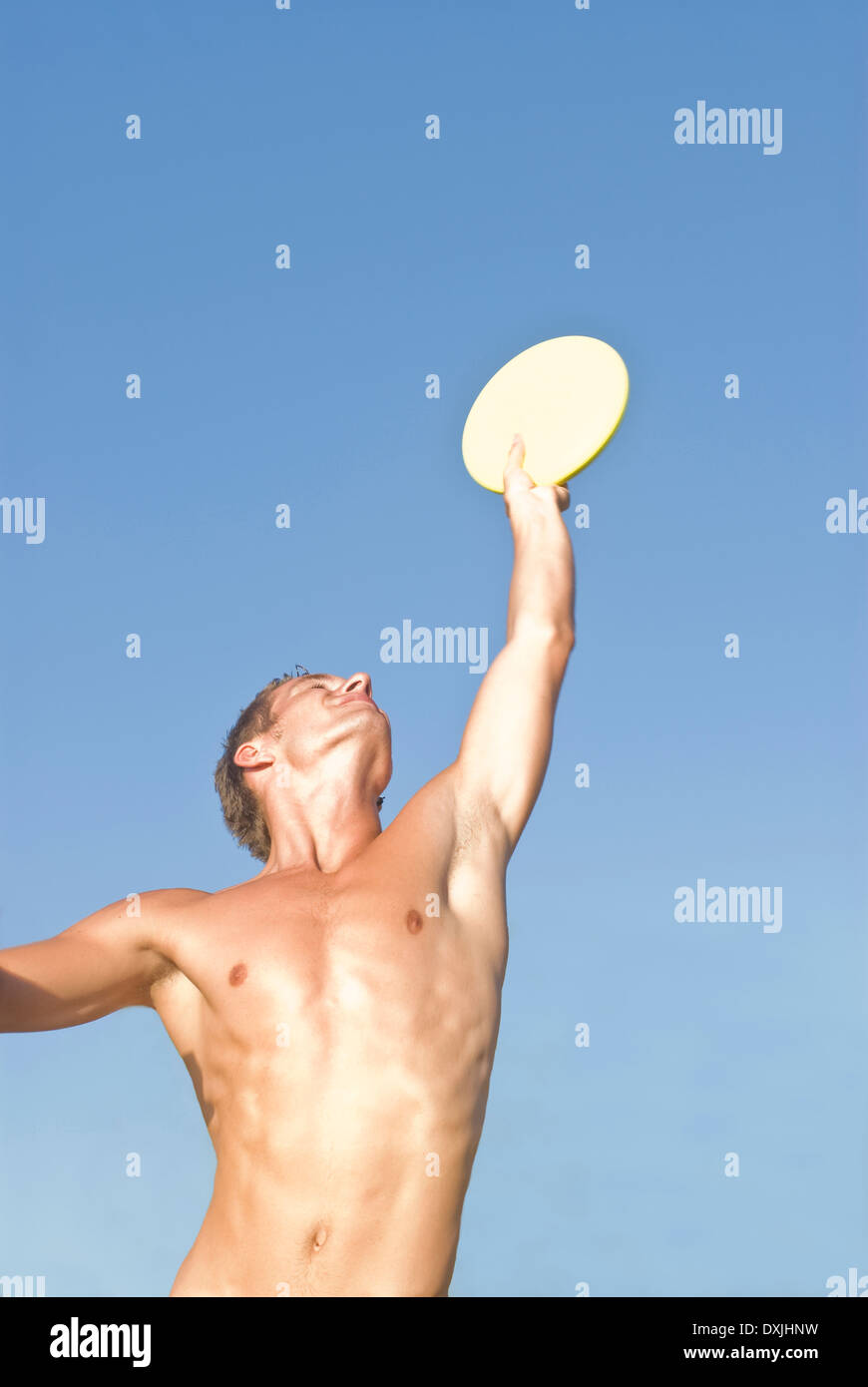 young man catching frisbee Stock Photo - Alamy