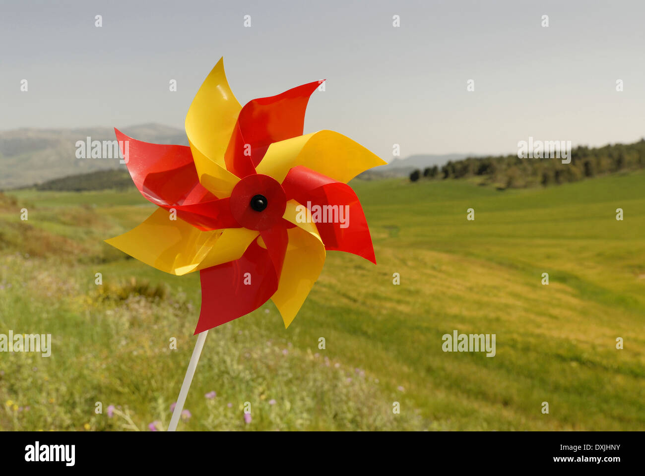 Windwheel on green rolling hills Stock Photo - Alamy