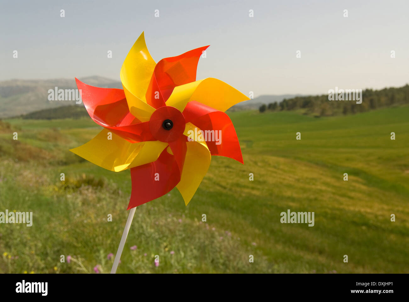 wind wheel over green fields Stock Photo - Alamy