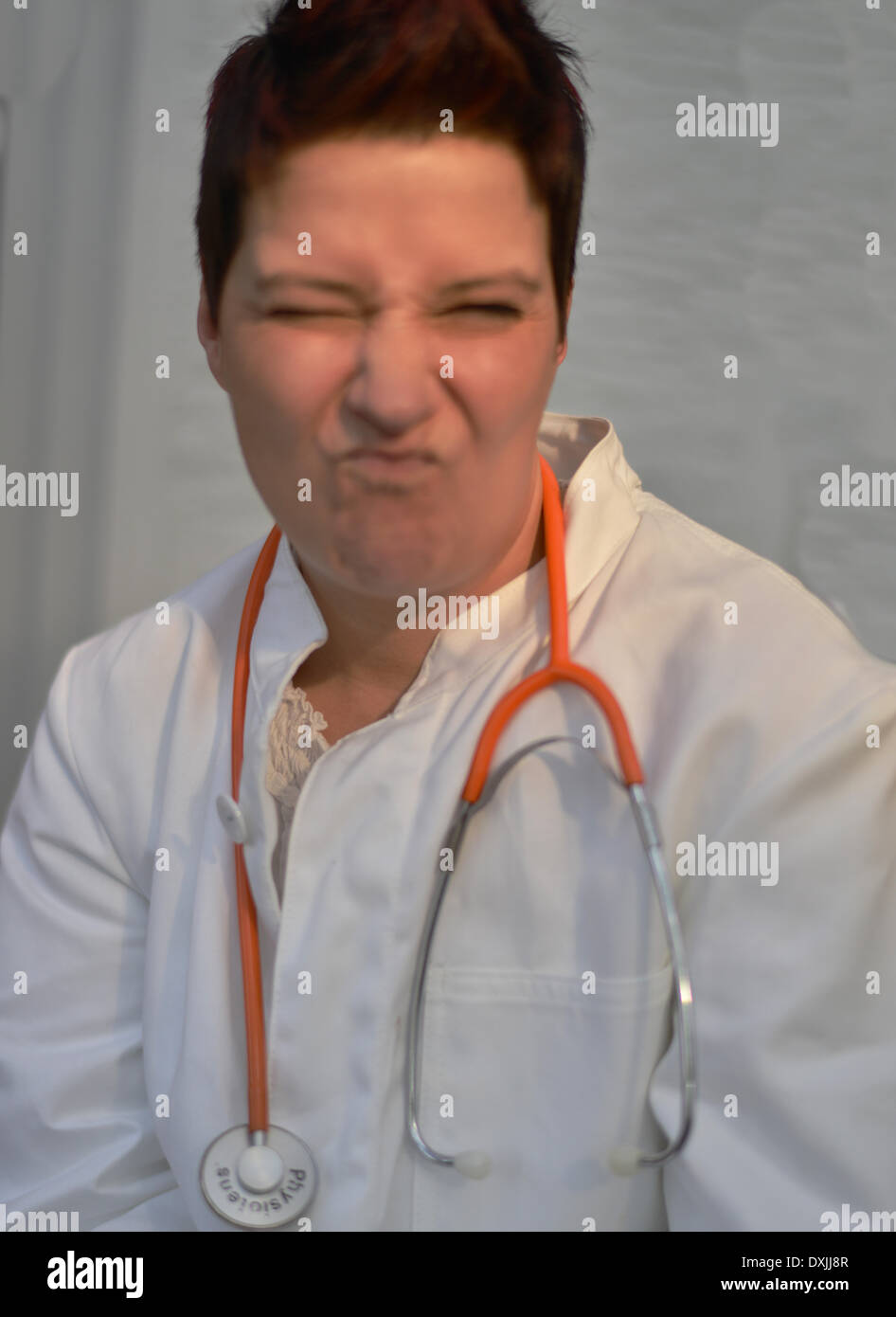 A doctor in a white coat and stethoscope with facial expressions. Taken ...