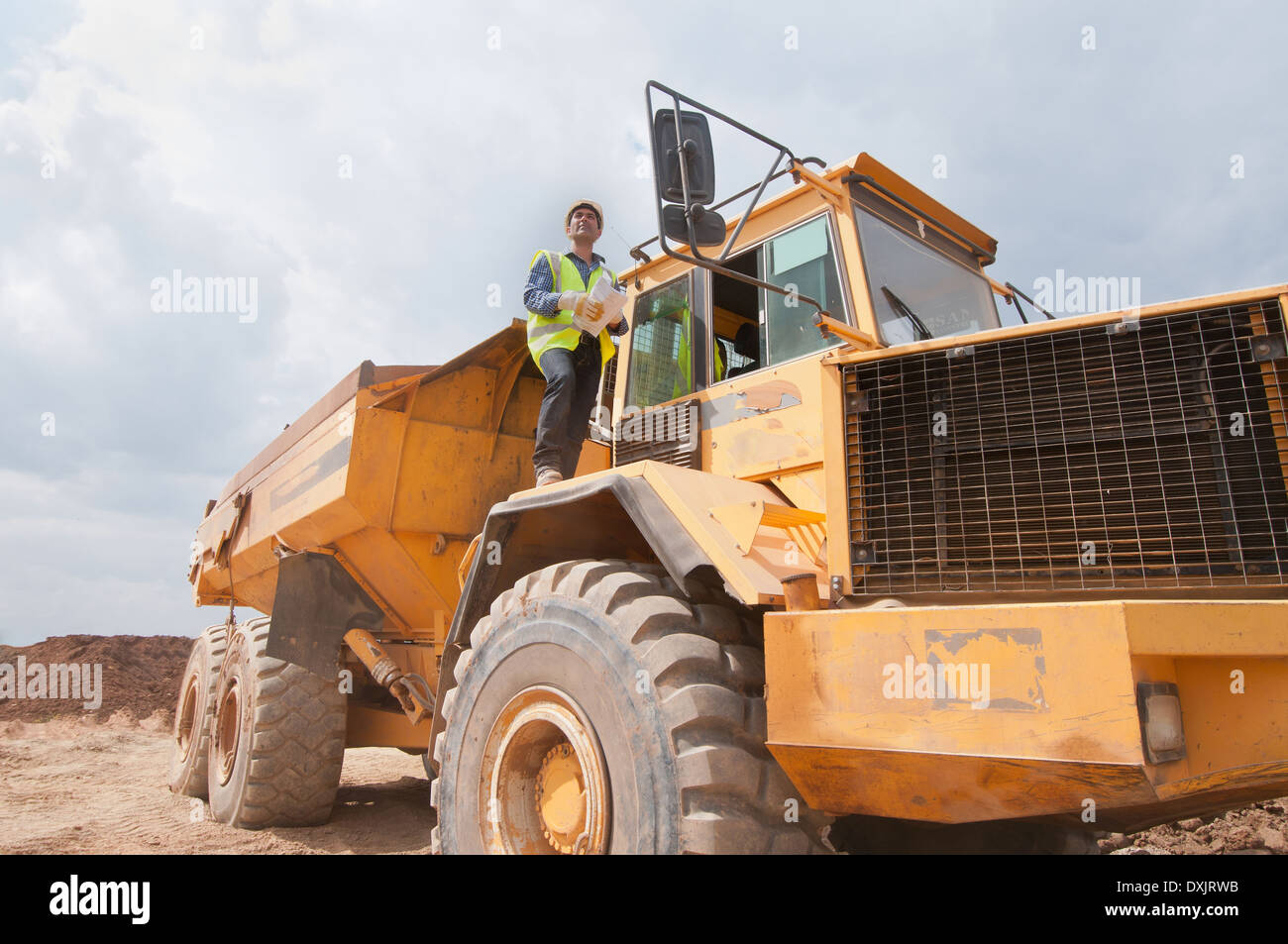 Engineer on dump truck in construction site Stock Photo - Alamy