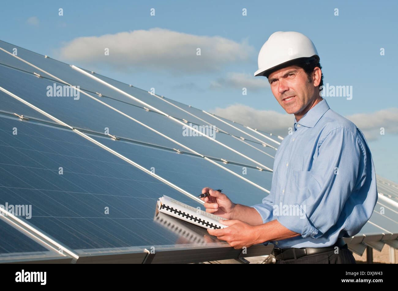 engineer with plans and solar panels Stock Photo - Alamy
