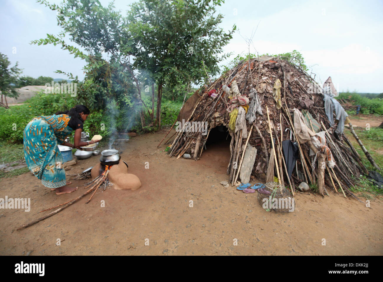 Tribal woman cooking food on hearth. Birhor tribe. Keredari village and ...