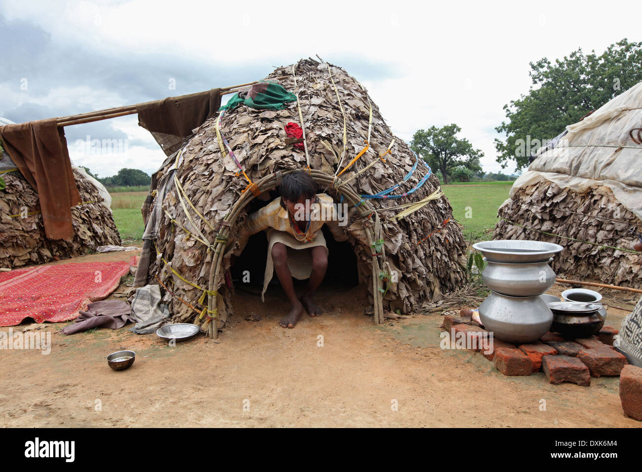 A tribal man coming out from the hut. Musahar or Bhuija tribe. Keredari ...
