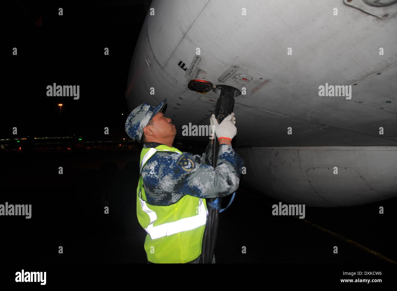 Perth. 27th Mar, 2014. A ground crew member refuels a Chinese IL-76 ...
