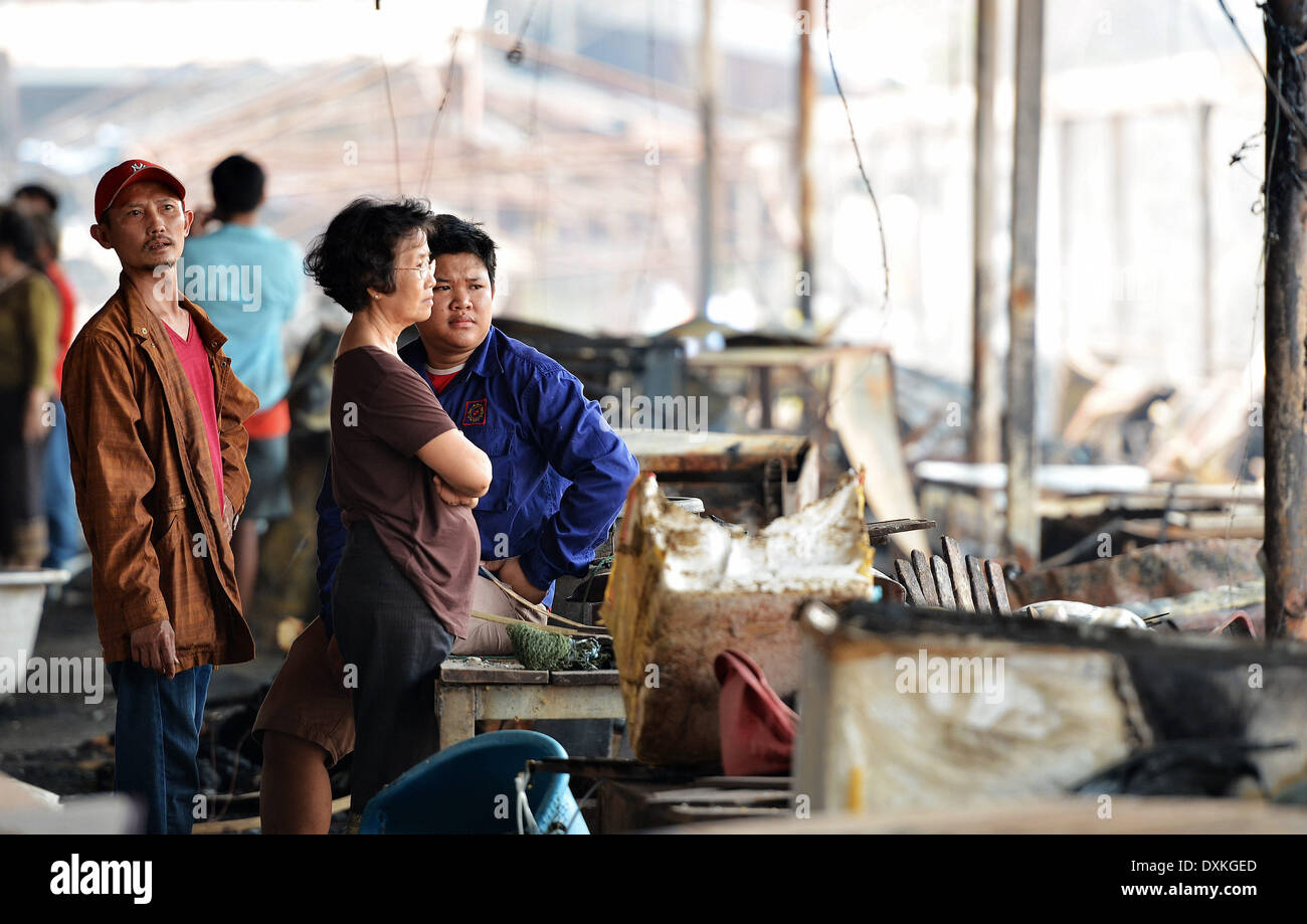 Vientiane, Laos. 27th Mar, 2014. People look at the Thong Khan Kham market after a fire in ...