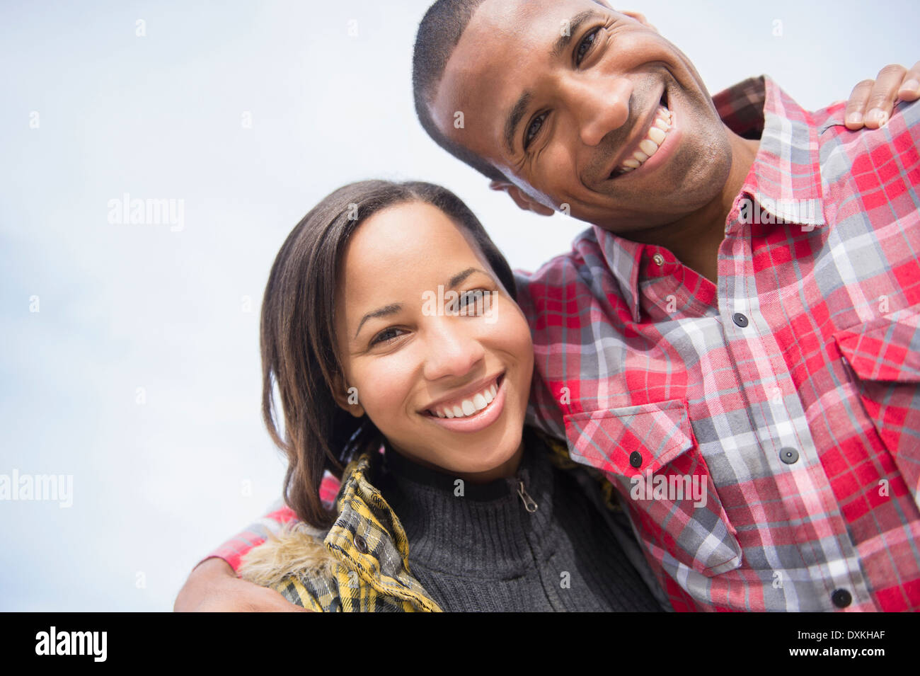 Portrait of smiling couple hugging Stock Photo - Alamy