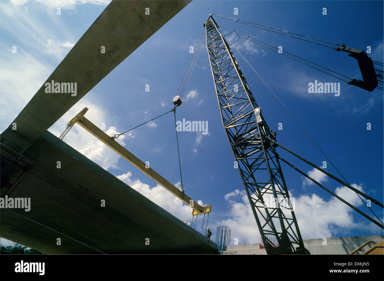 Construction crane lifting beam Singapore Stock Photo - Alamy