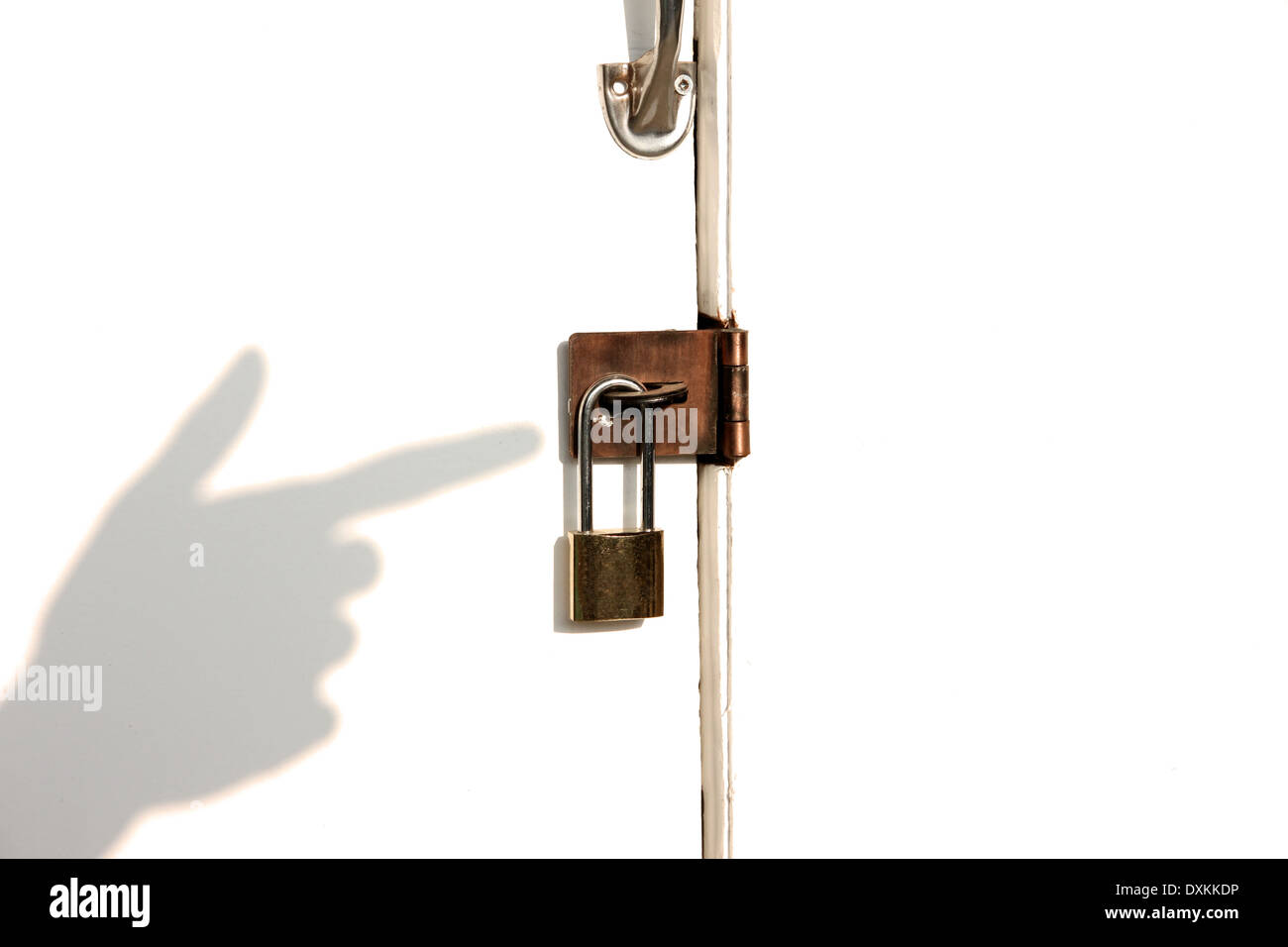 Shadow of fingers point to Padlock on a white door Stock Photo - Alamy