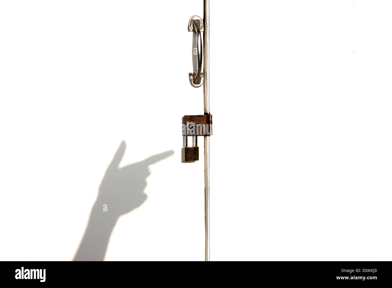 Shadow of fingers point to Padlock on a white door Stock Photo - Alamy