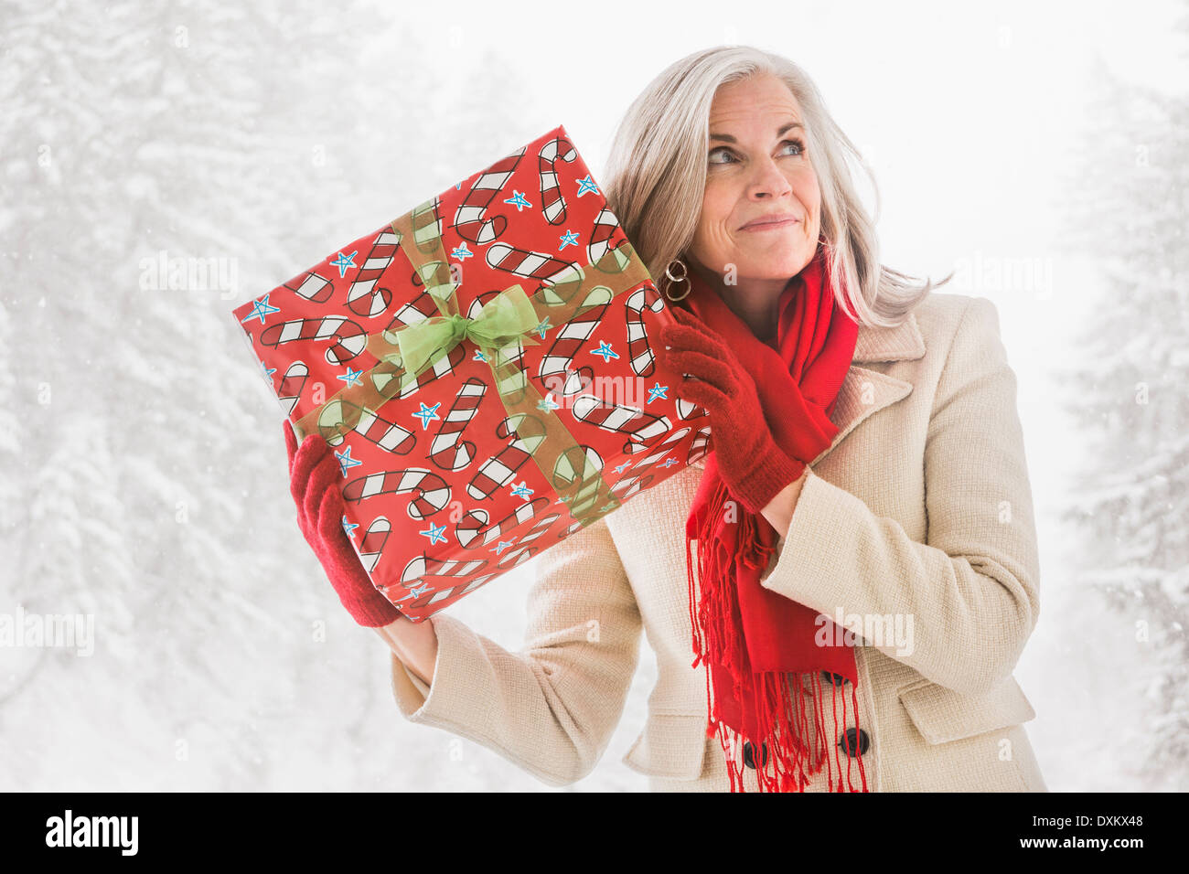 Woman shaking gift box hi-res stock photography and images - Alamy