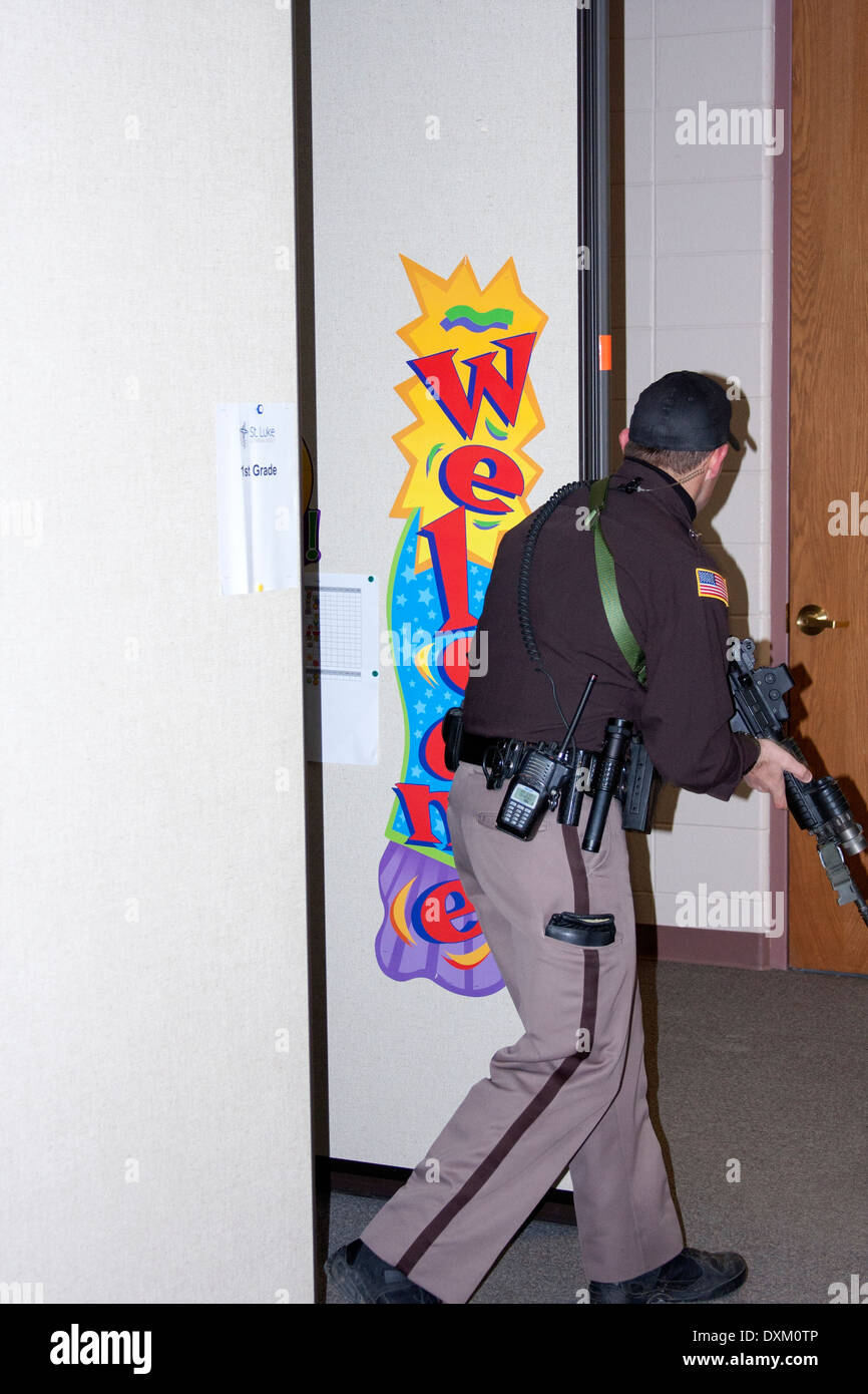 Sheriff personnel scanning rooms in a church for a shooter hiding Stock ...