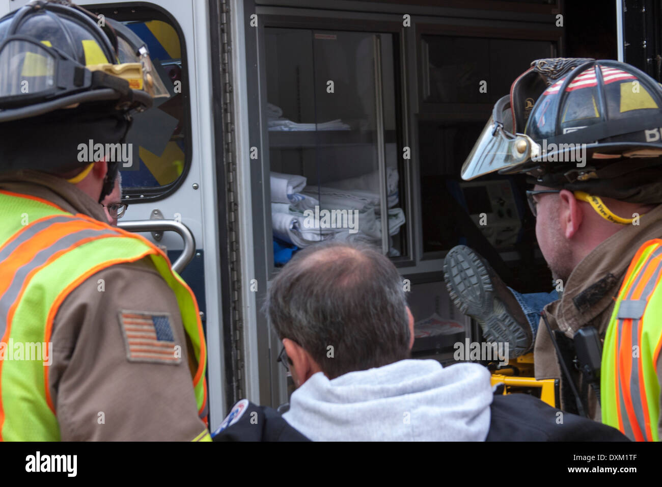Firefighters carrying multiple victims to the ambulance Stock Photo - Alamy