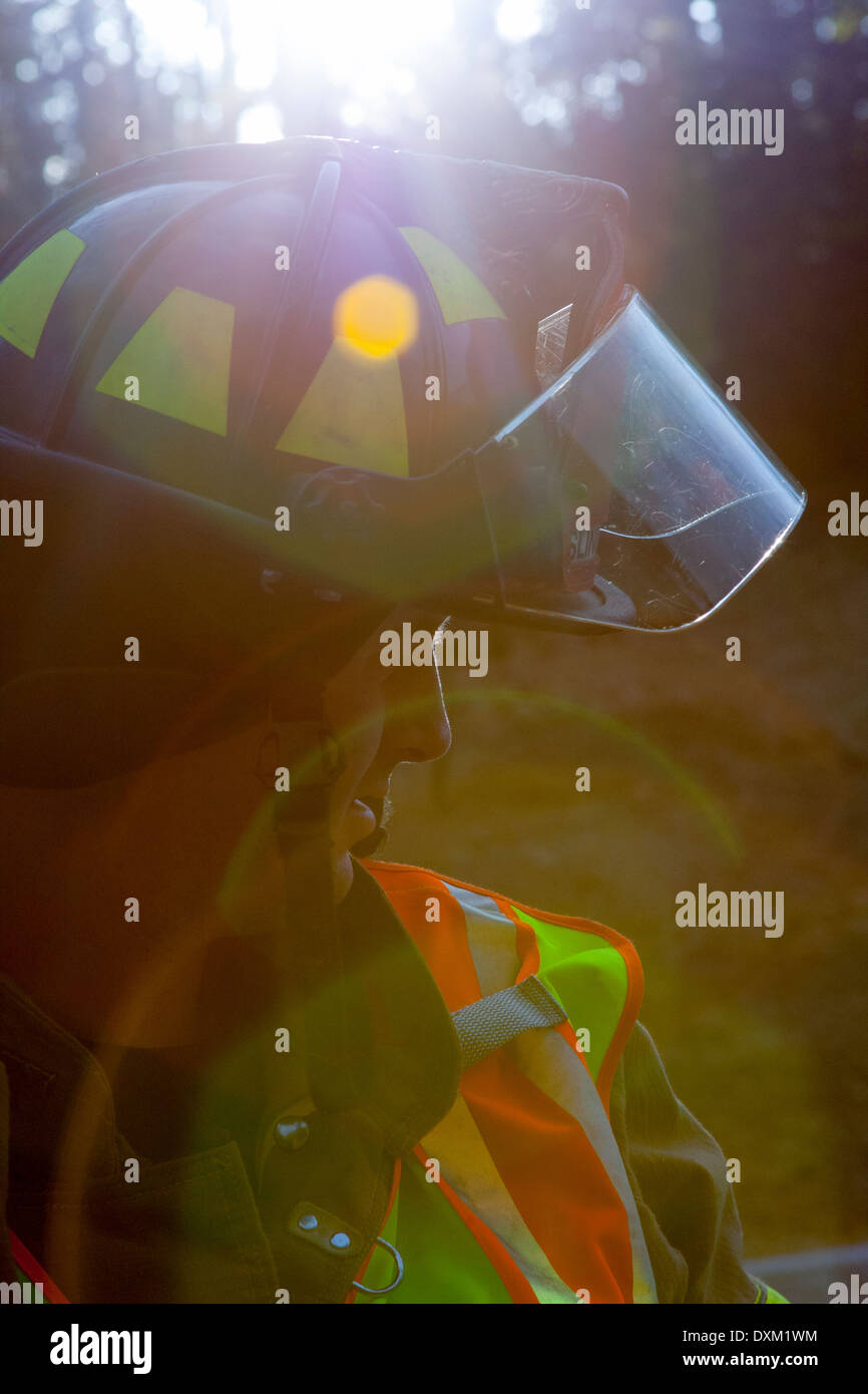 Firefighter profile in a sun ray Stock Photo - Alamy