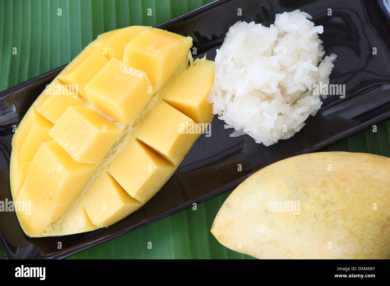 Ripe mango and sticky rice in dish on banana leaves,local Thai foods ...
