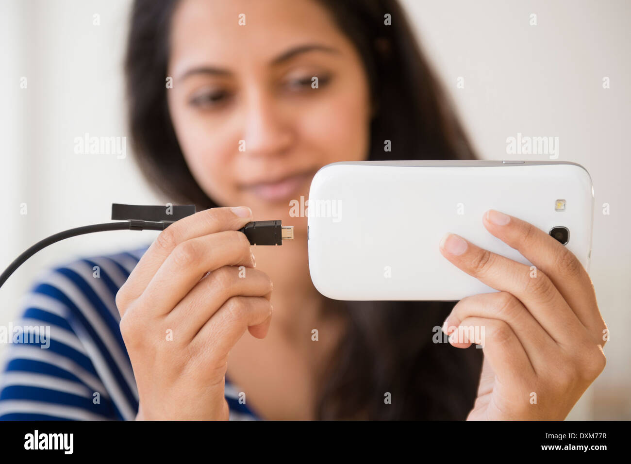 Close up of Asian woman connecting cell phone to battery Stock Photo ...