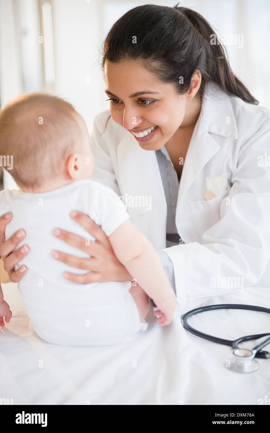 Doctor smiling at baby Stock Photo - Alamy