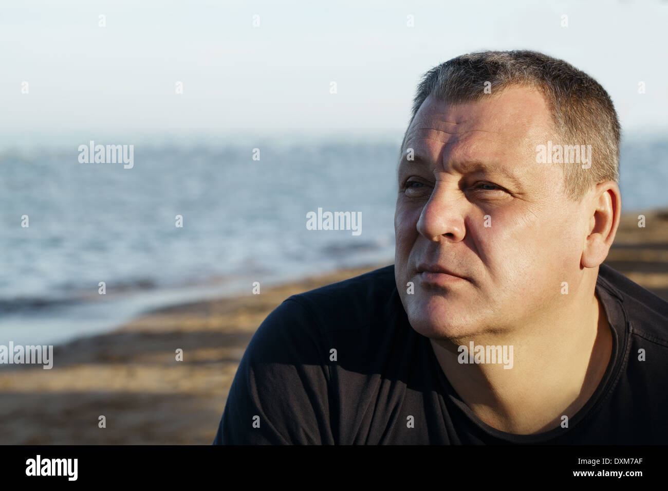 Wistful man sitting beach sad hi-res stock photography and images - Alamy