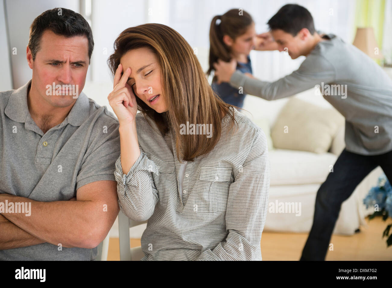 Frustrated Caucasian parents listening to children fight Stock Photo ...