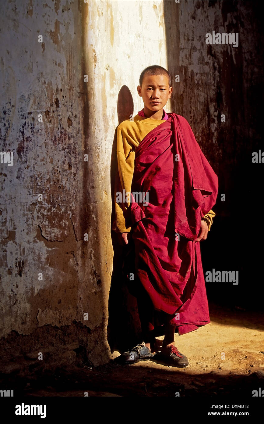 Young monk in shaft of sunlight at Gangtey Dzong. Digitally Manipulated ...