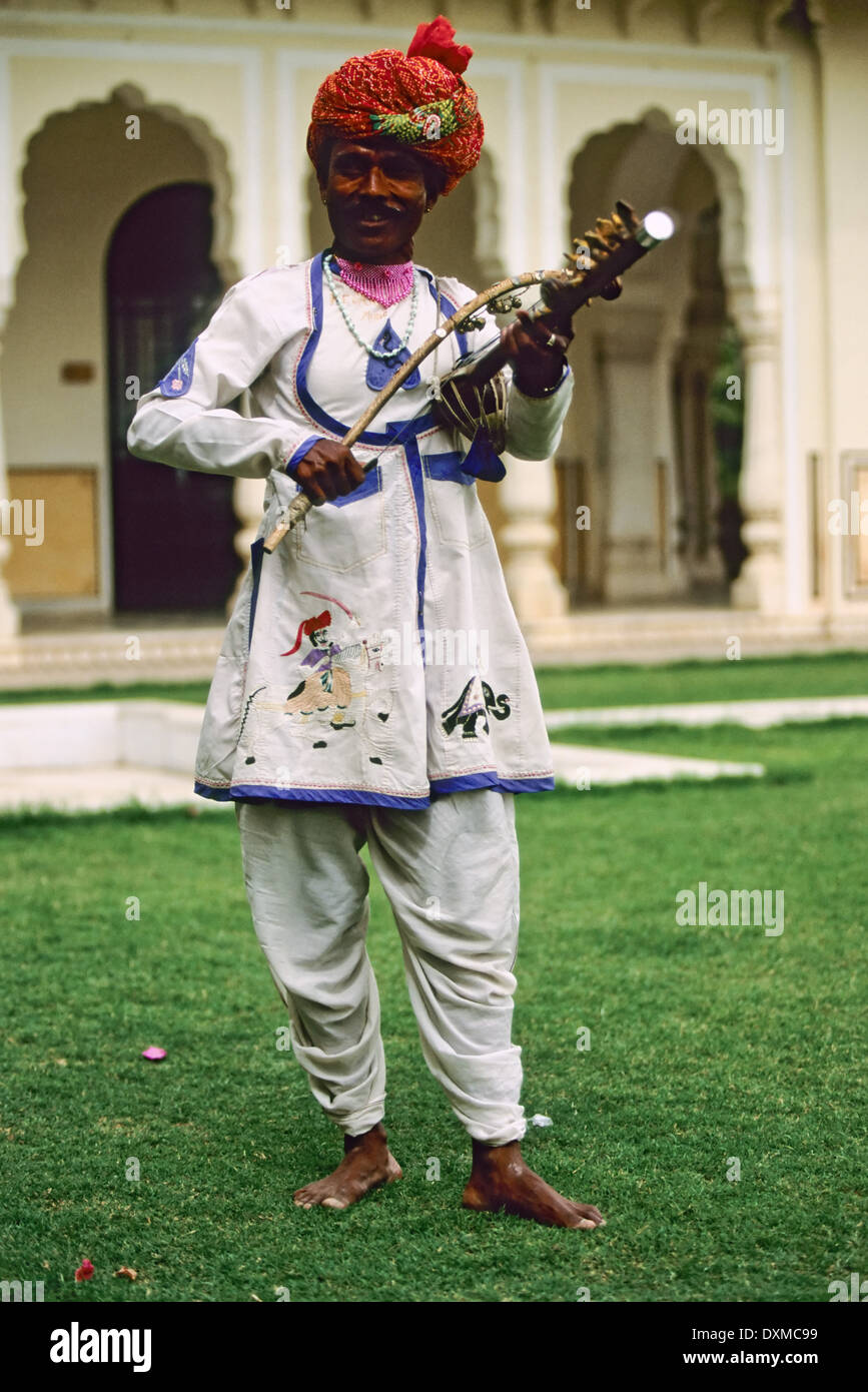 Indian musician with red turban playing stringed instrument Stock Photo ...