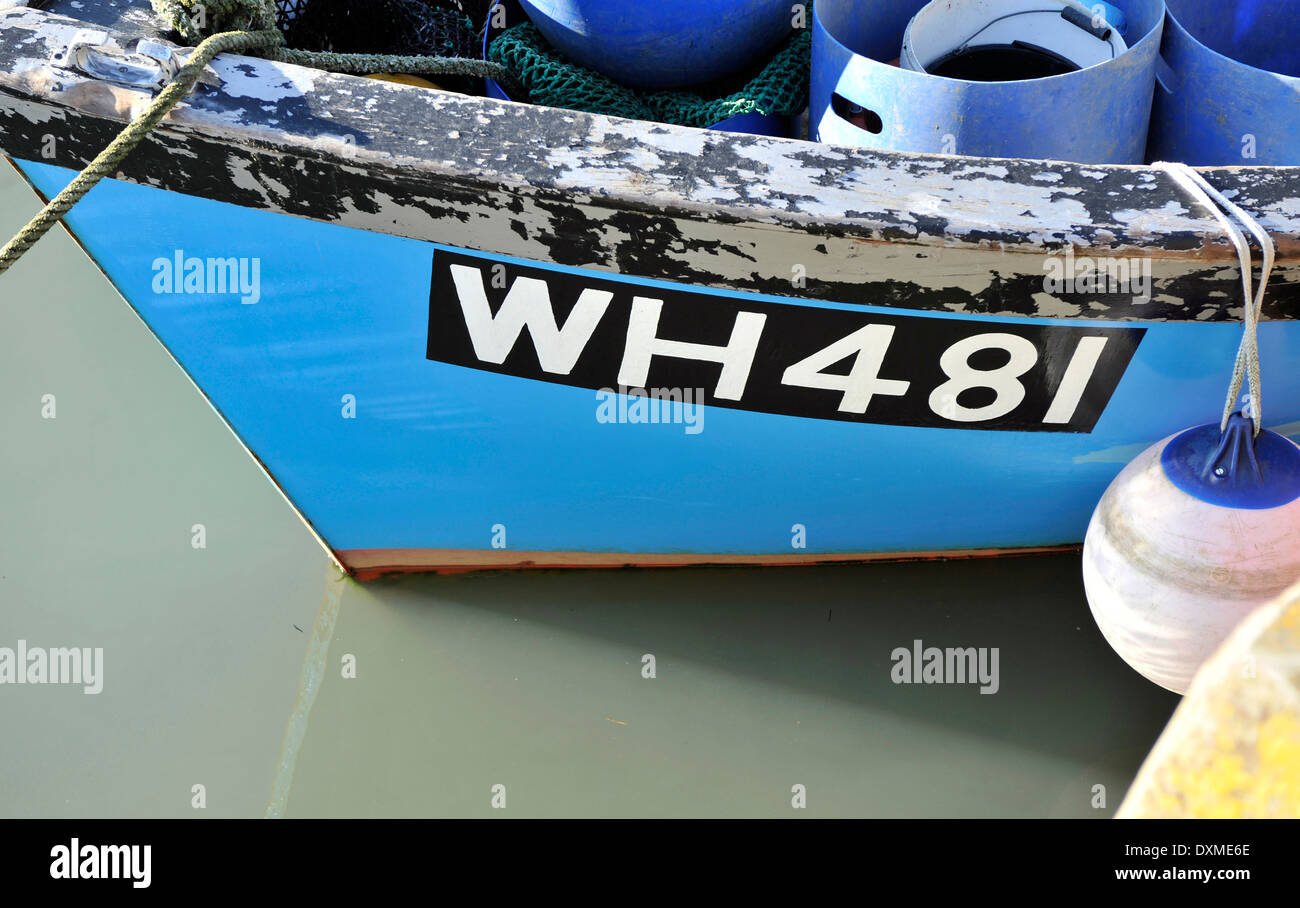 moored fishing boat with blue hull Stock Photo - Alamy
