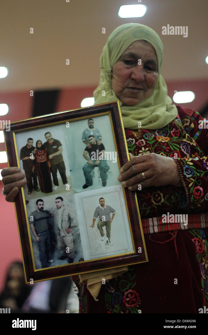 RAMALLAH, PALESTINE- MARCH 27: Palestinan woman holding a poster with a ...