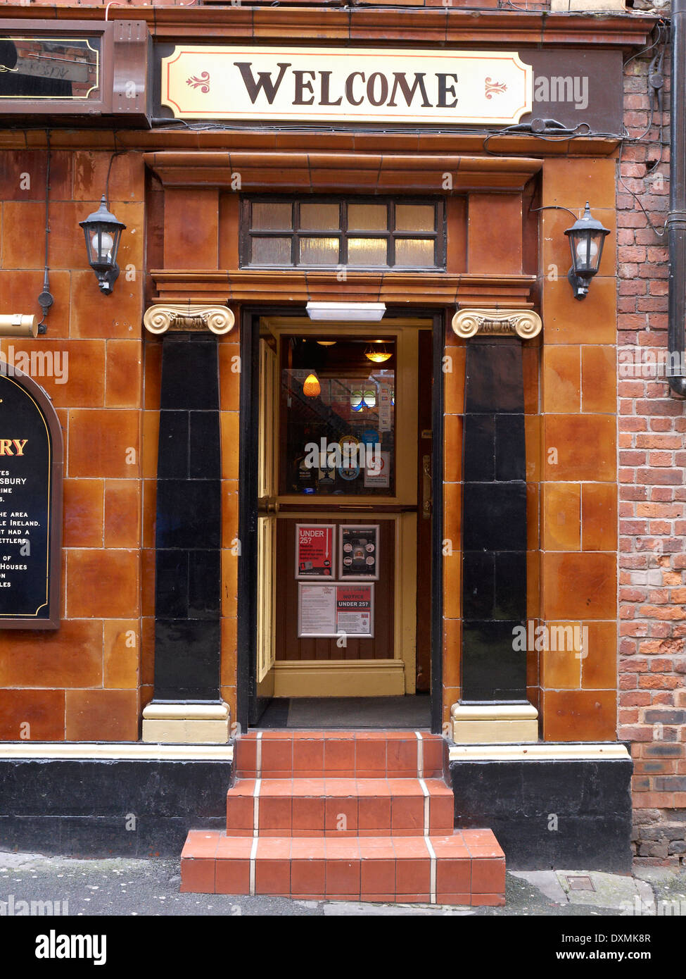 Old fashioned welcome sign above pub entrance in Manchester UK Stock ...