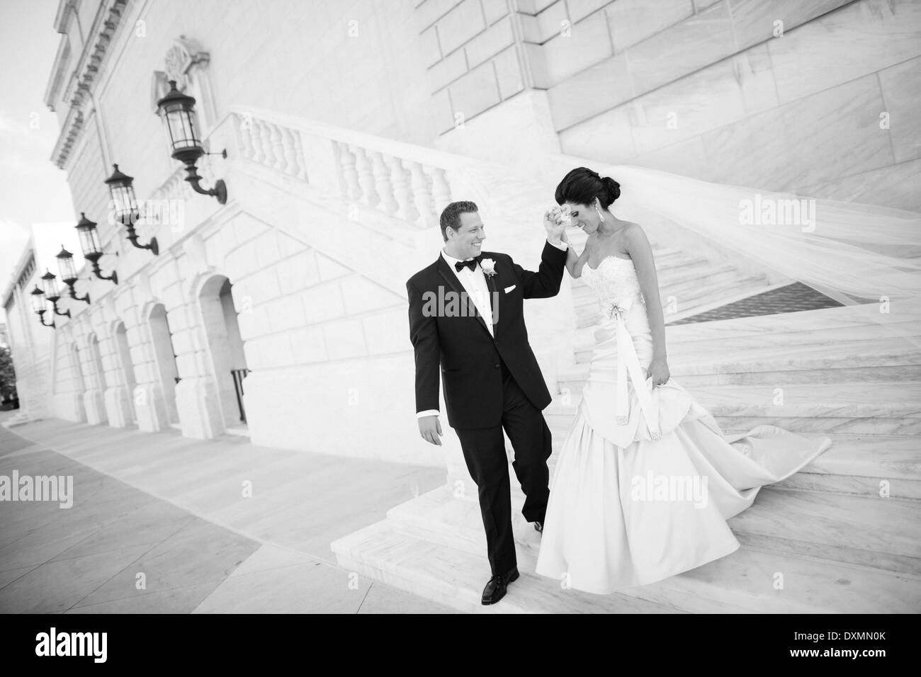 Bride and Groom walking down stairs Stock Photo - Alamy