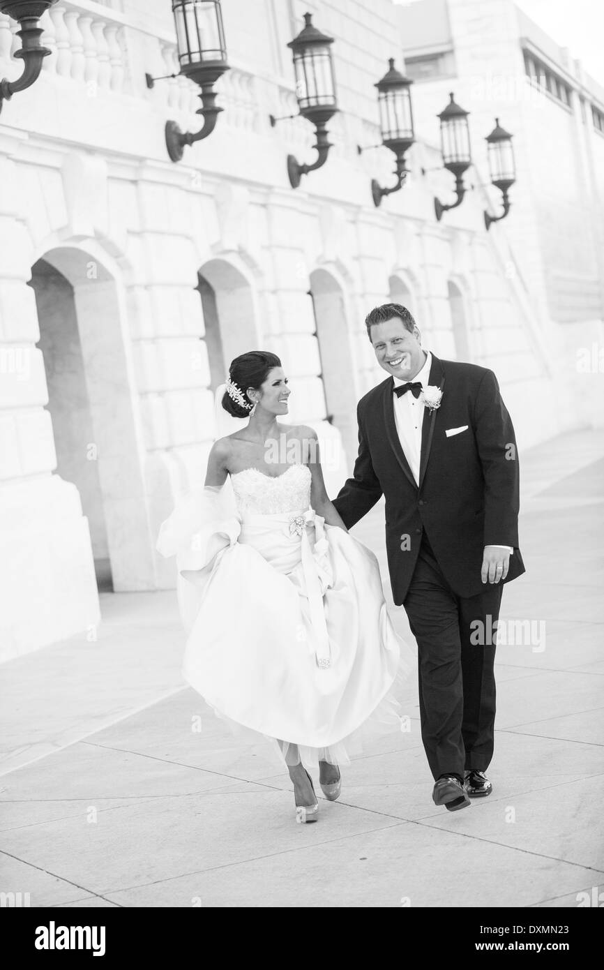 Walking man woman holding Black and White Stock Photos & Images - Alamy