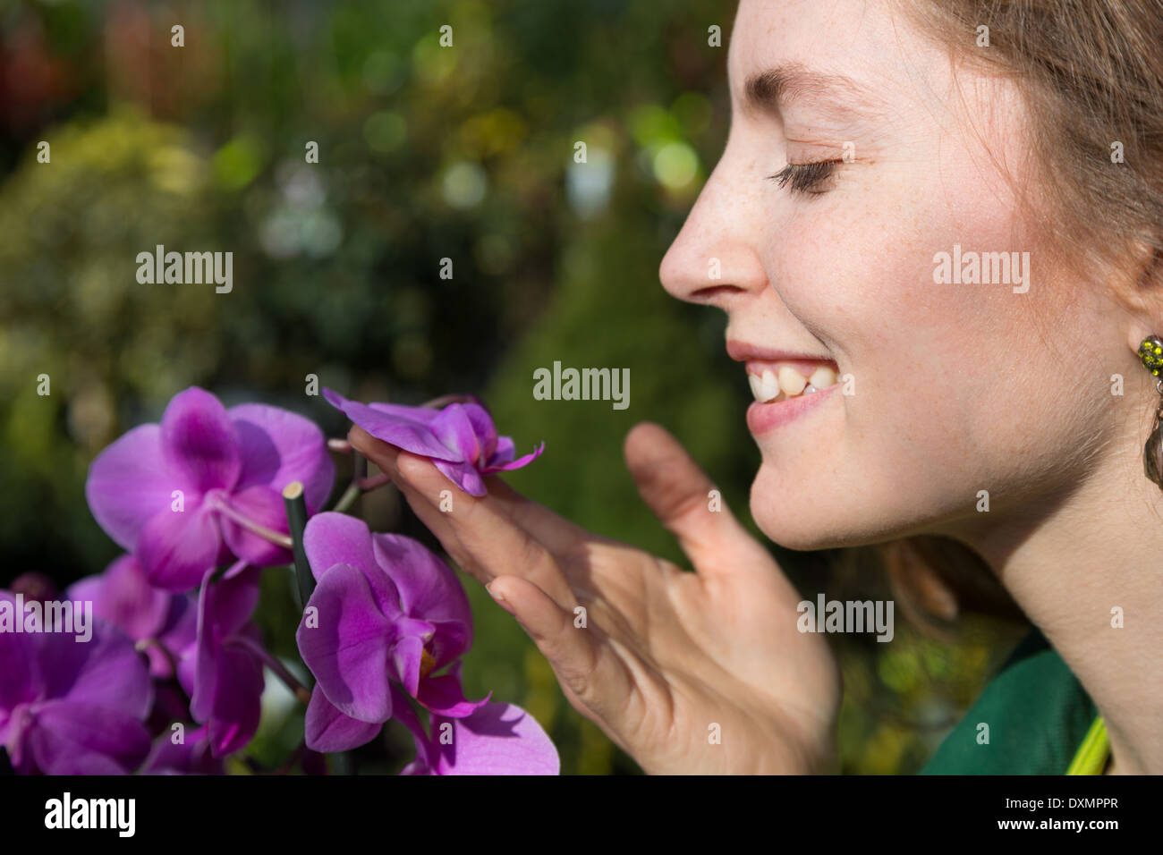 Woman smelling garden flower hi-res stock photography and images - Alamy