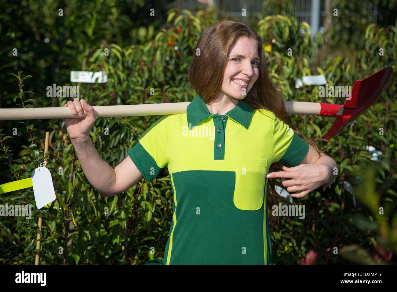 Farmer or gardener posing with shovel in garden nursery Stock Photo - Alamy
