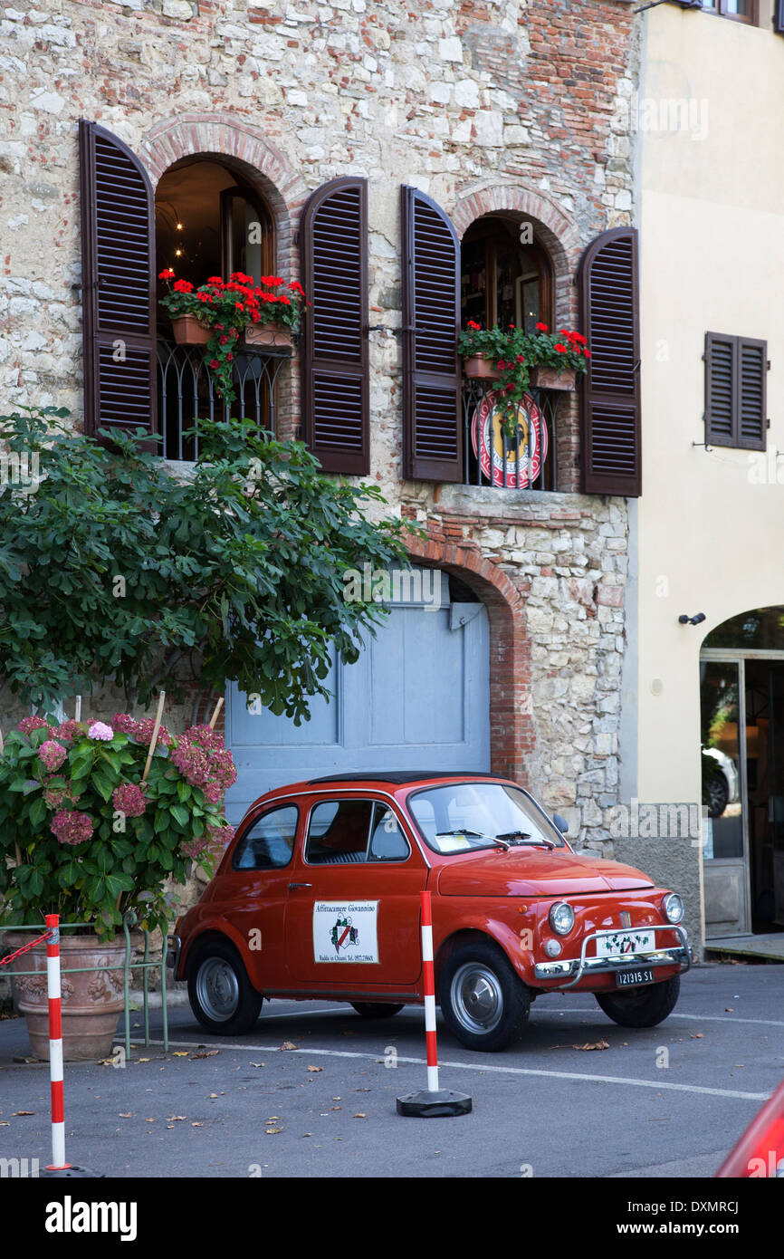 Cute red car outside garage of quaint restaurant in Radda, Italy Stock ...