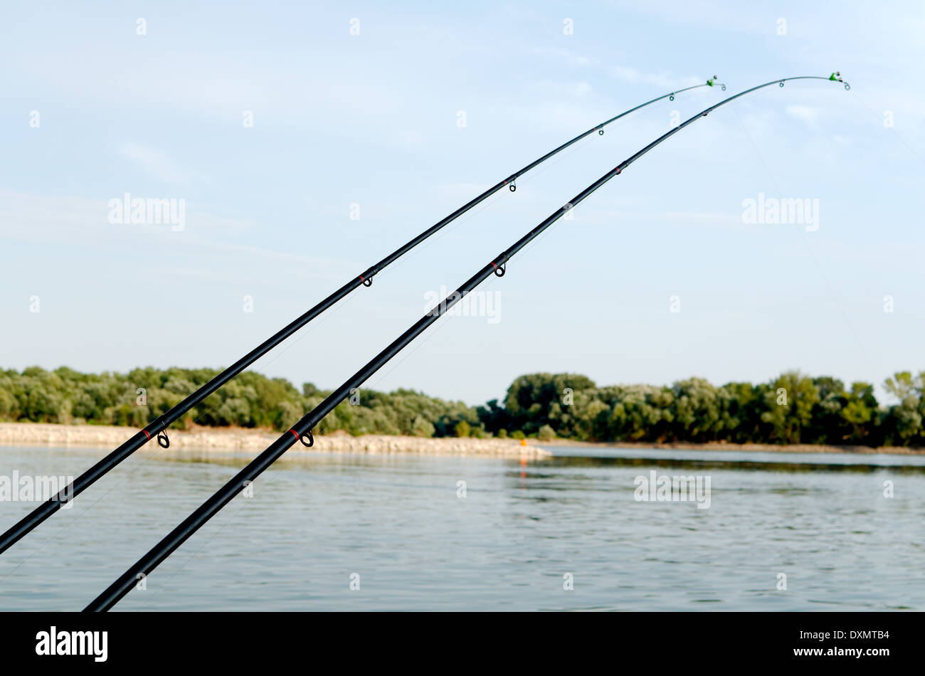 Two Black Fishing Rods by the River Stock Photo - Alamy
