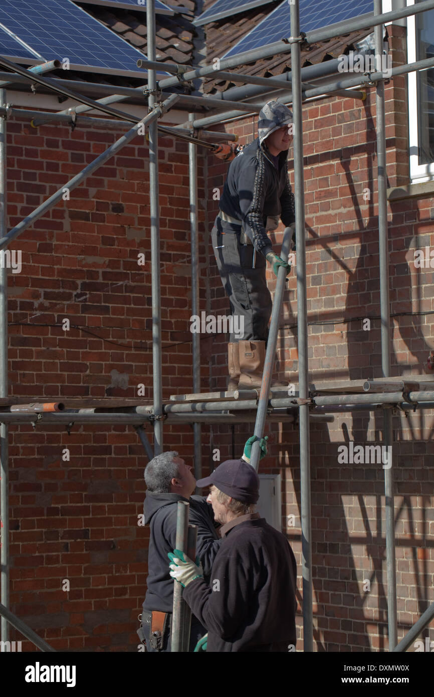 Dismantling scaffolding after the erection of photovoltaic solar panels ...