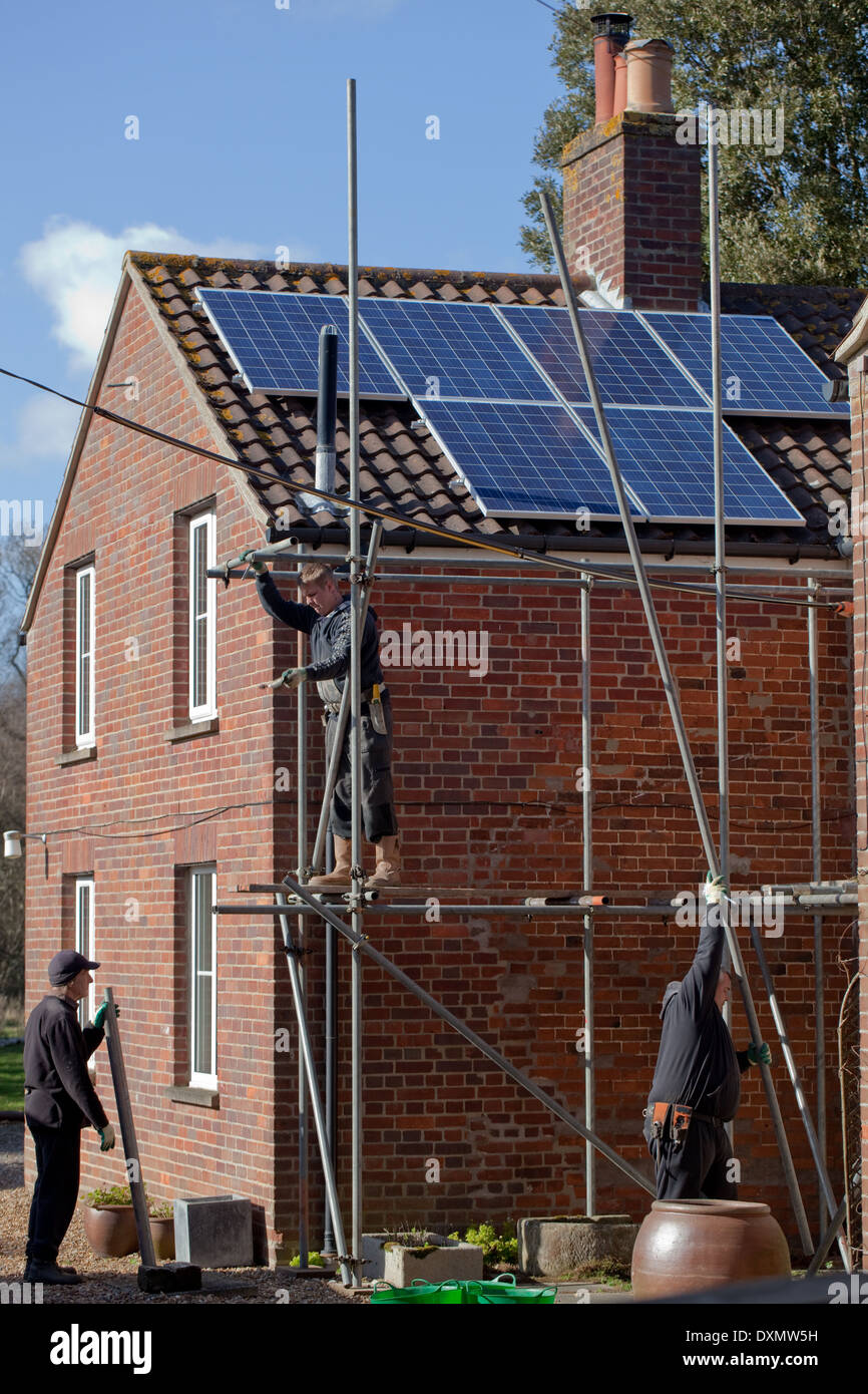Dismantling scaffolding after the erection of photovoltaic solar panels ...