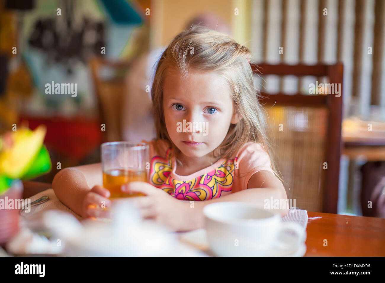 Adorable little girl having early breakfast at resort restaurant Stock ...