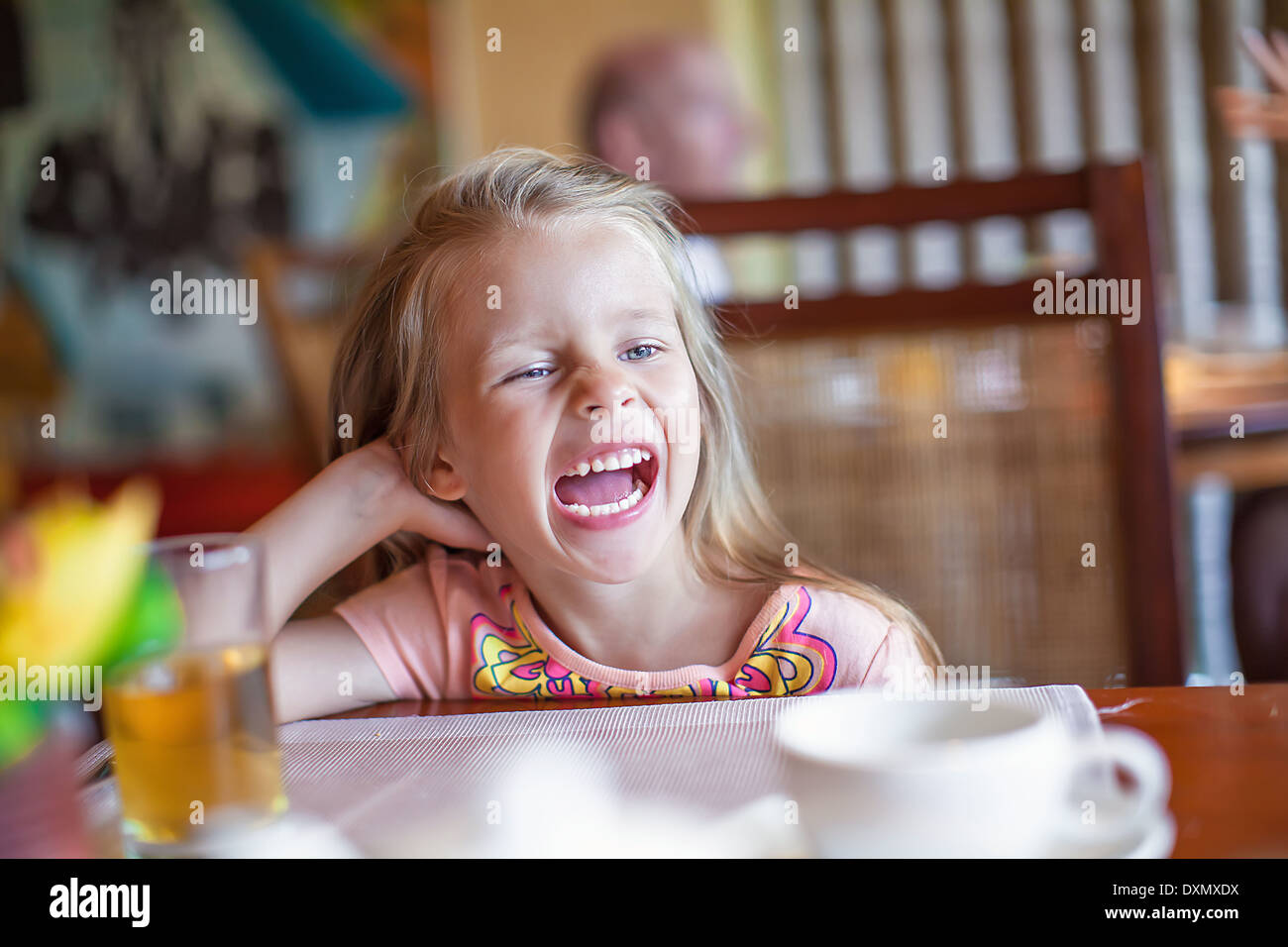 Smiling little girl having early breakfast Stock Photo - Alamy
