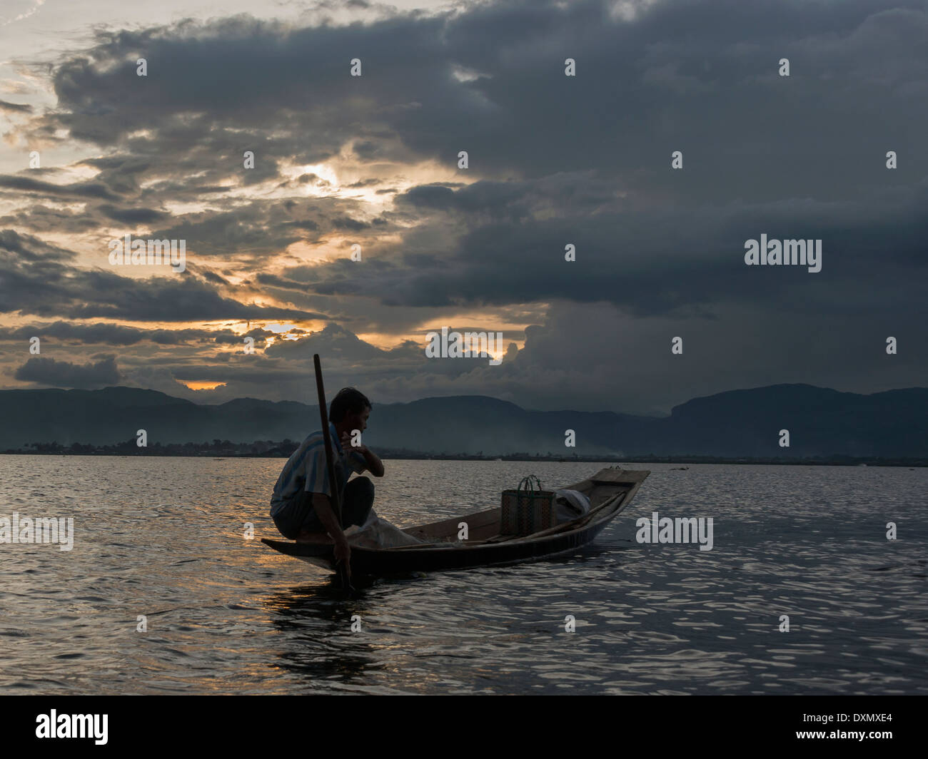 Fisherman in dugout canoe at sunset, Inle Lake, Myanmar Stock Photo - Alamy