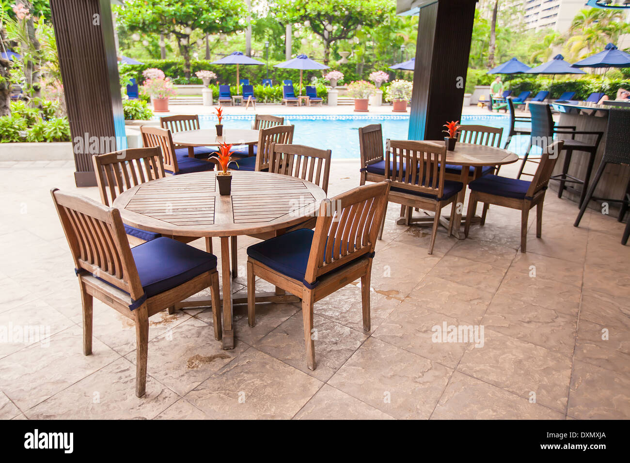 Hotel outdoor cafe with white table and chairs near pool Stock Photo ...