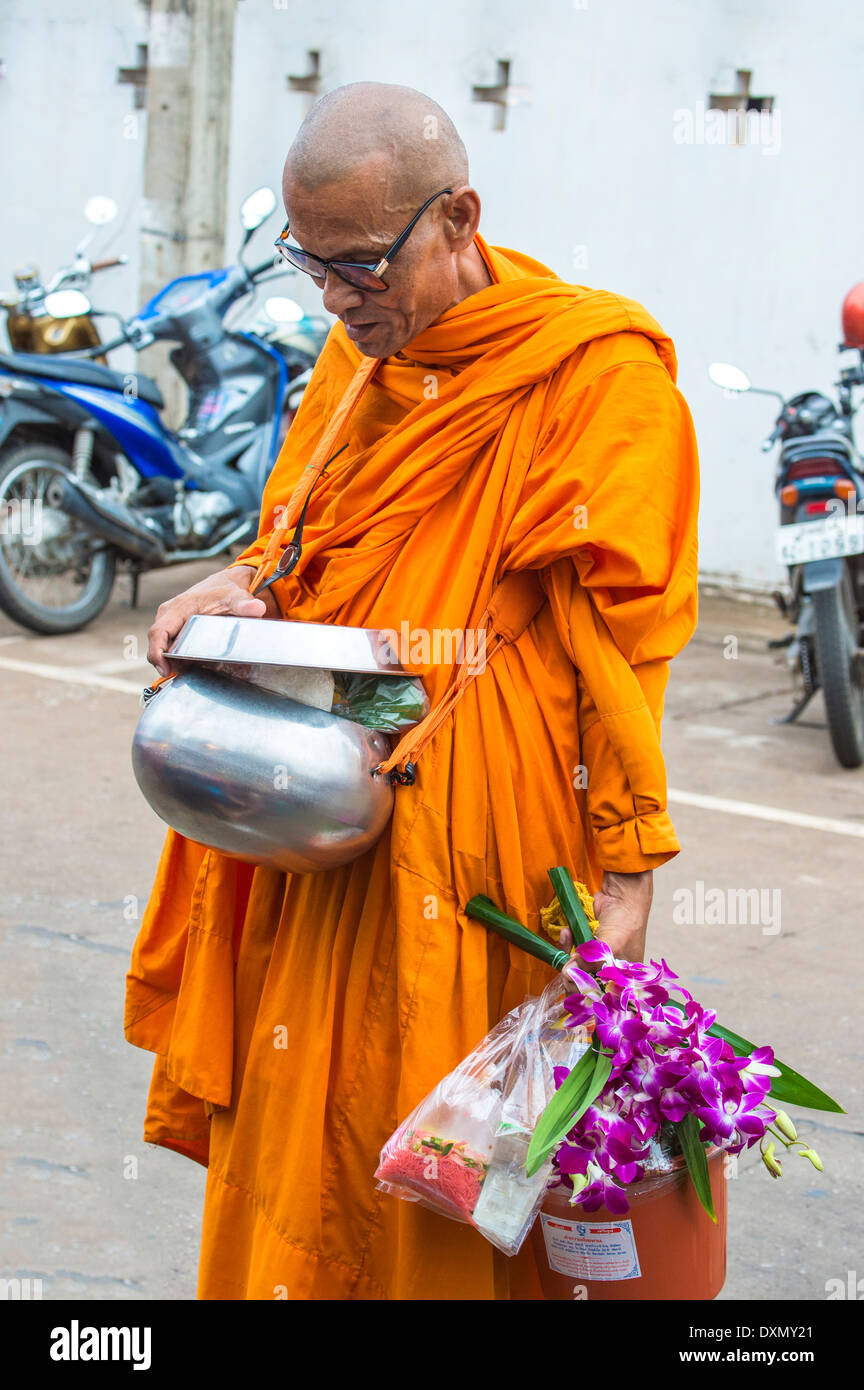 Monk receiving food, Ayutthaya, Thailand Stock Photo - Alamy