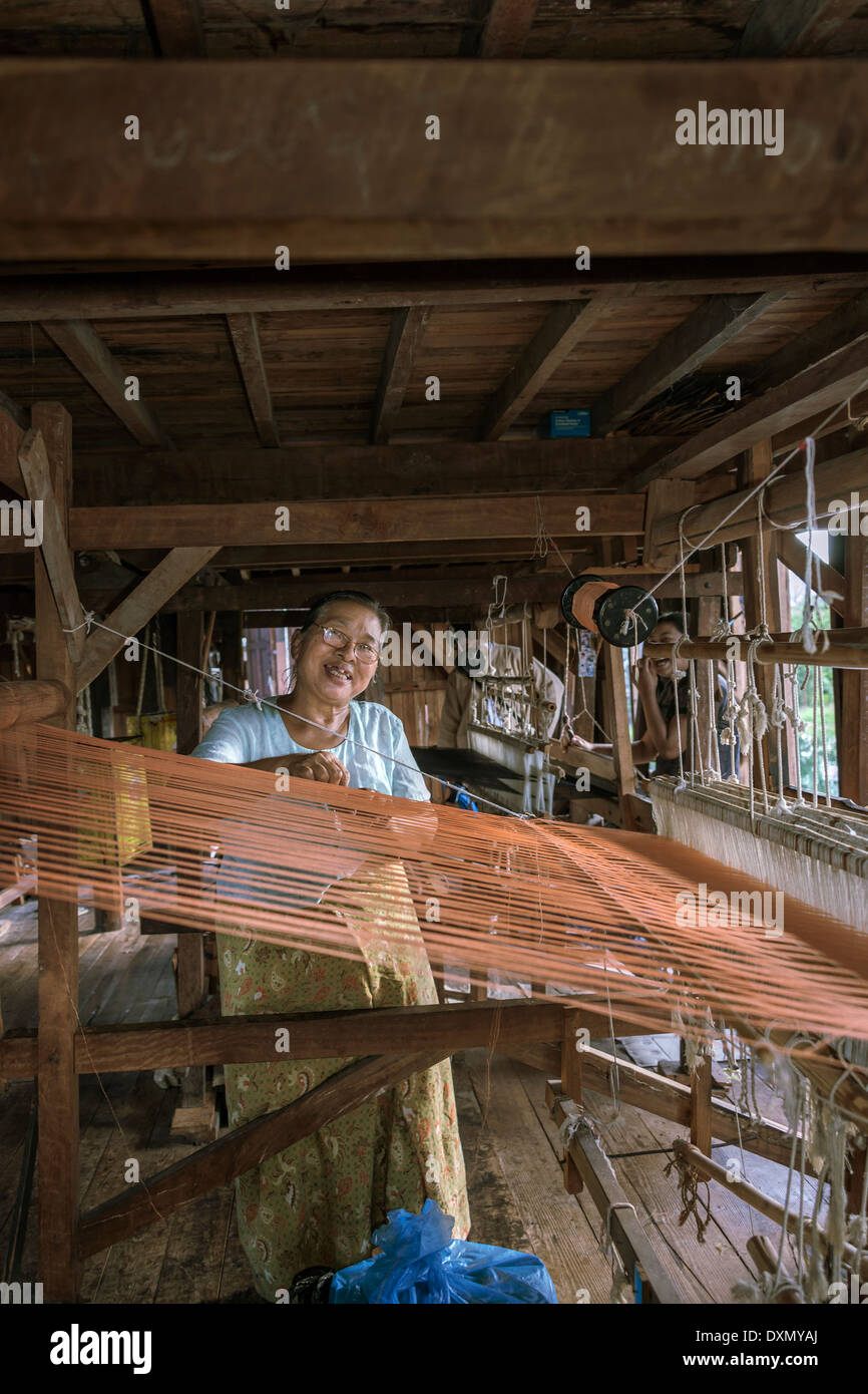 Woman setting up the warp threads on a hand loom, Inle Lake, Myanmar ...