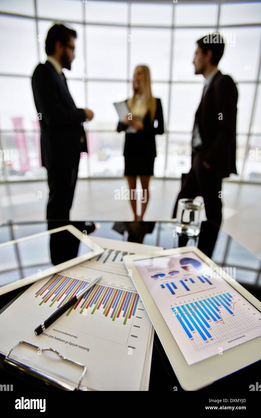 Technological devices and financial document at workplace on background ...