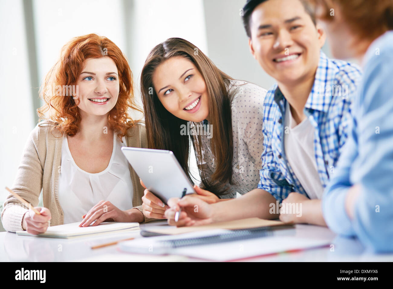 Smart groupmates discussing something at lesson Stock Photo - Alamy